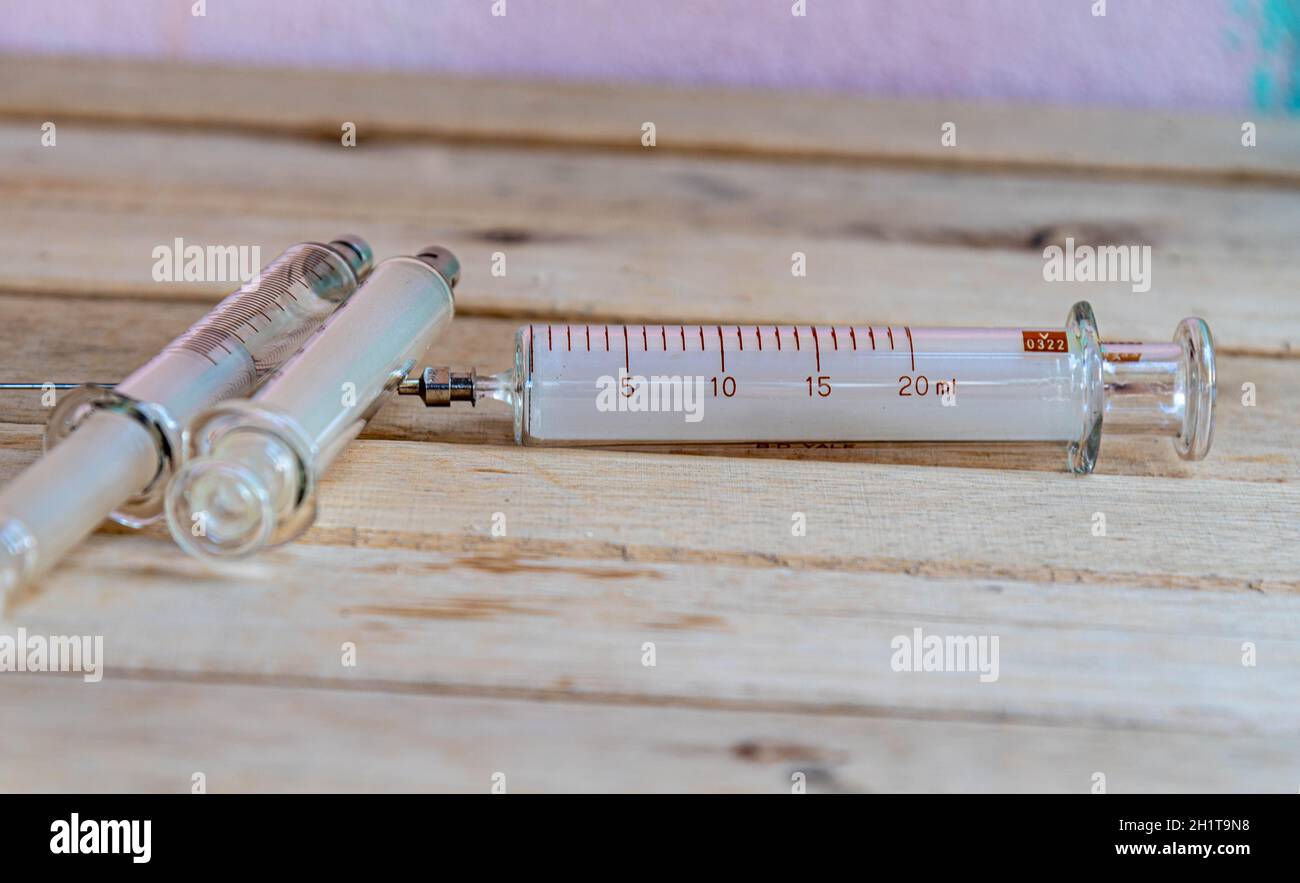 Medical syringes. Glass syringes. Utensils to combat covid-19. Wood ...
