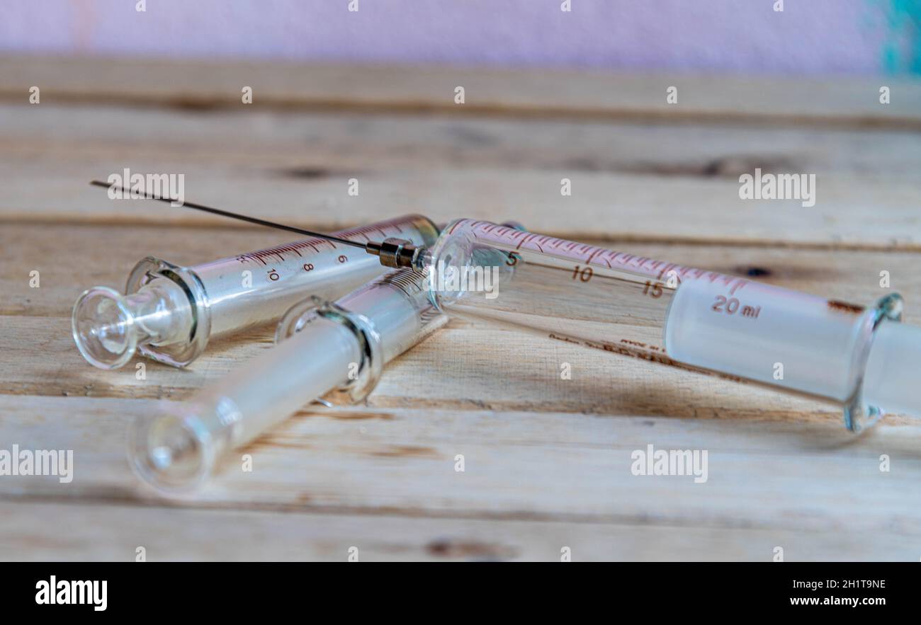 Medical syringes. Glass syringes. Utensils to combat covid-19. Wood ...