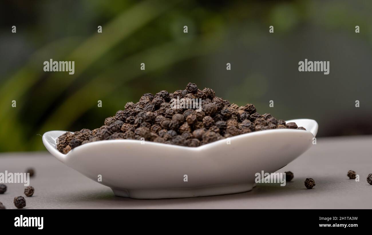 Close up black pepper seeds or peppercorns (dried seeds of piper nigrum ...