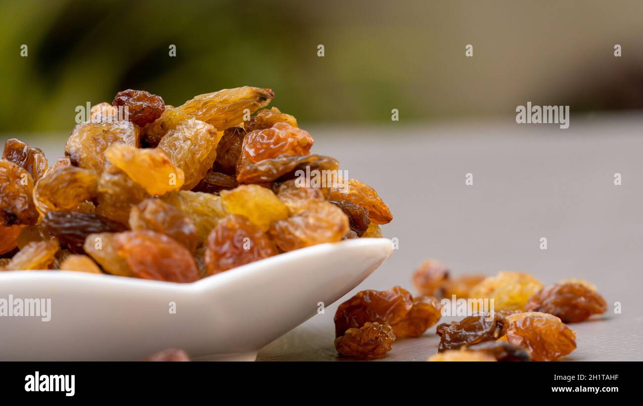 Isolated dried grapes. yellow is the highest grade on white background ...