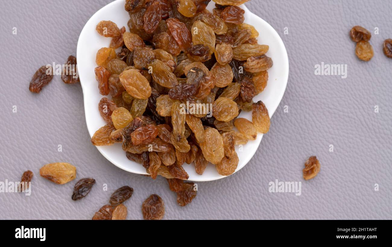 Isolated dried grapes. yellow is the highest grade on white background ...