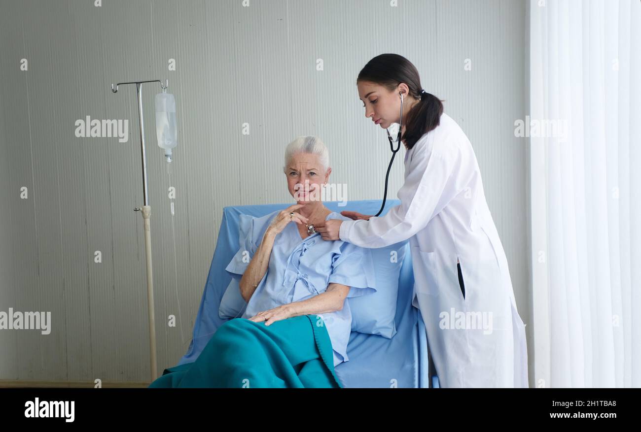 Doctor check up on elderly female patient in hospital. Doctor ...