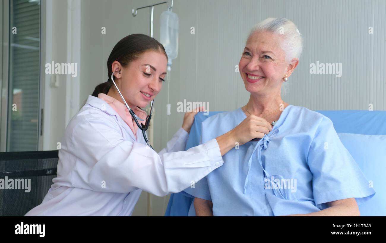 Doctor check up on elderly female patient in hospital. Doctor ...