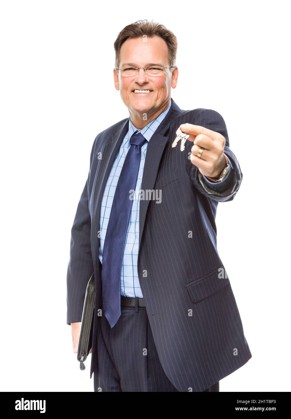 Handsome Real Estate Agent Holding Out Keys to New Home Isolated on a ...