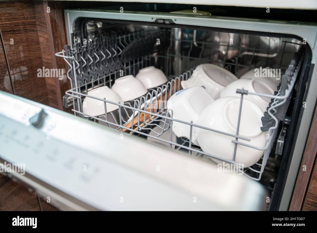 Open dishwasher with dishes inside in the kitchen Stock Photo - Alamy
