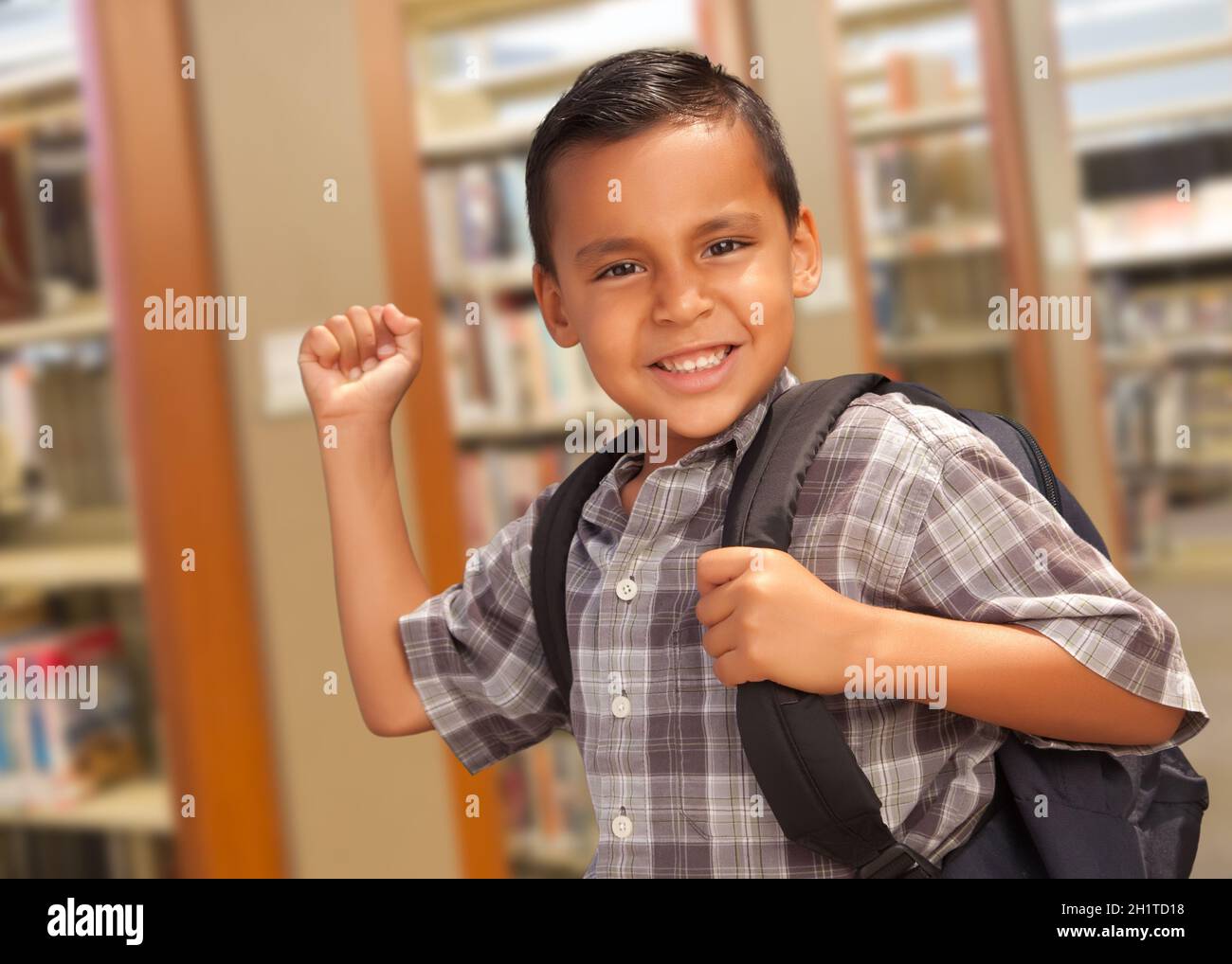 Happy Hispanic Student Boy with Backpack in the Library Stock Photo - Alamy