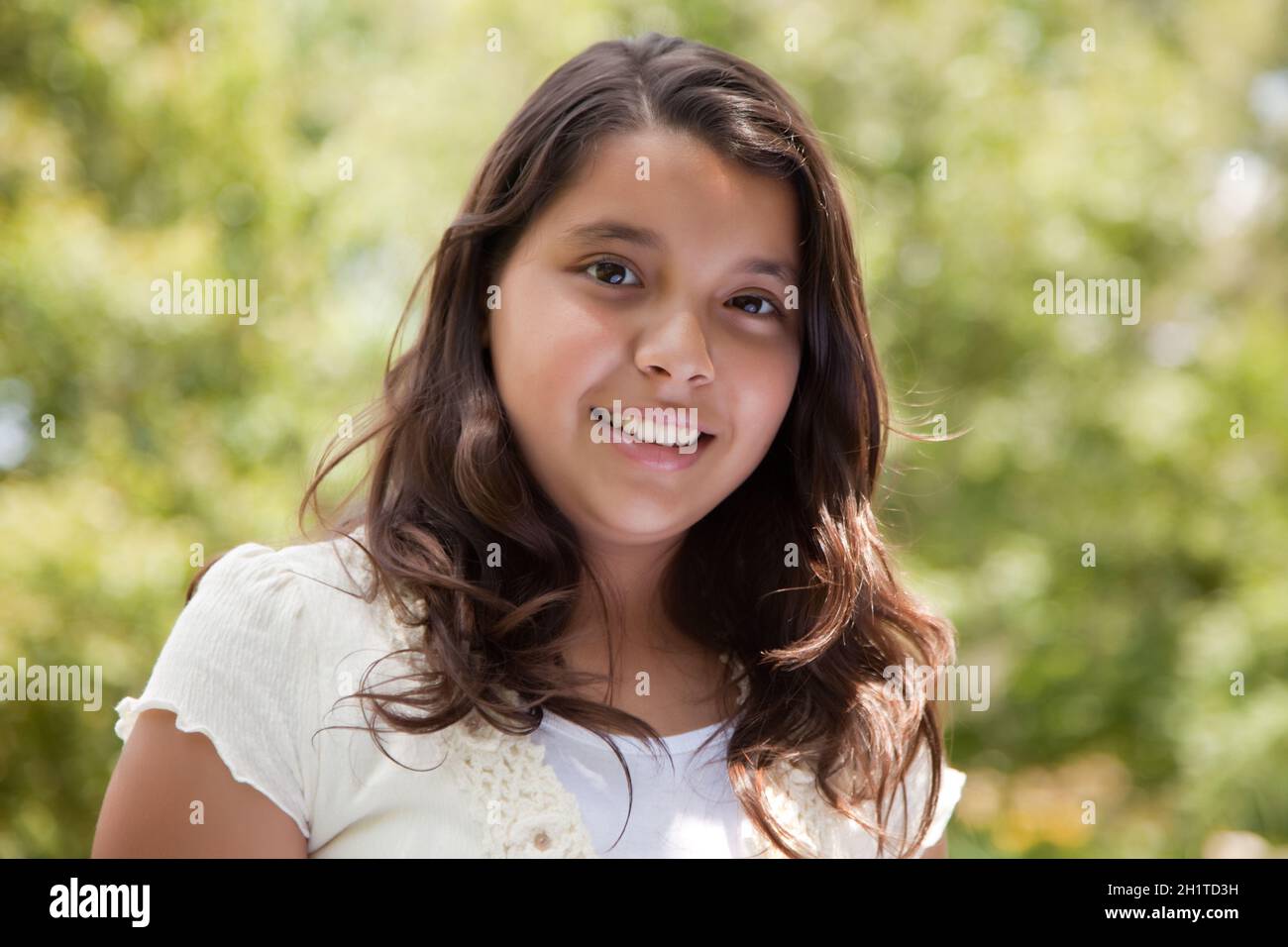 Cute Happy Hispanic Girl in the Park Stock Photo - Alamy