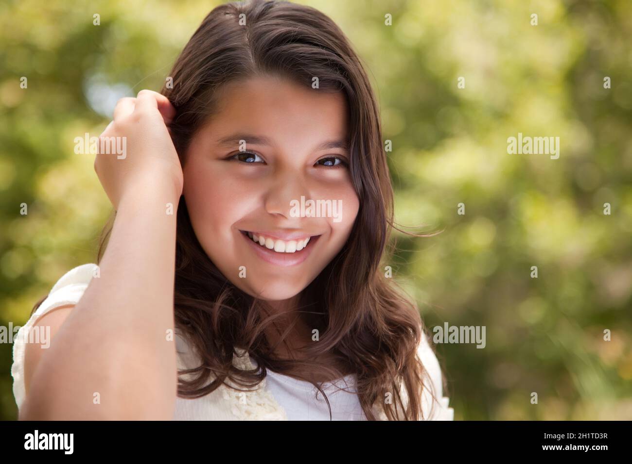 Cute Happy Hispanic Girl in the Park Stock Photo - Alamy
