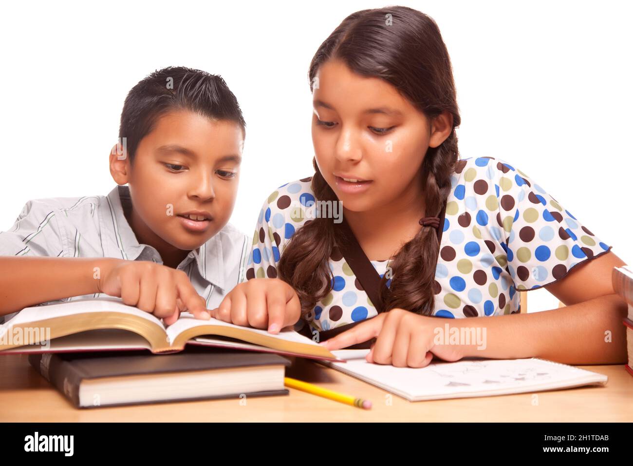 Hispanic Brother and Sister Having Fun Studying Together Isolated on a ...