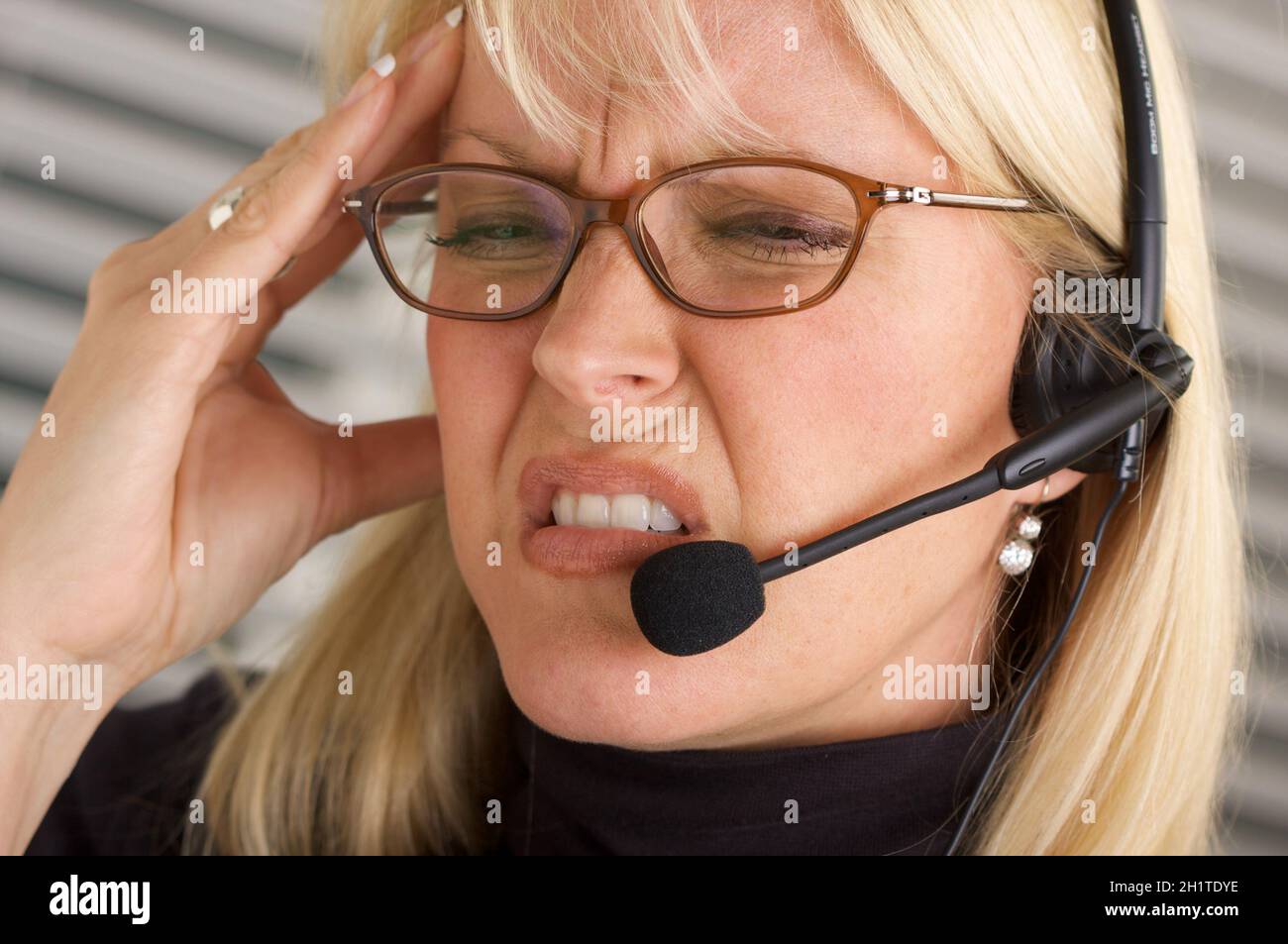 Businesswoman with phone headset show signs of having a headache Stock ...