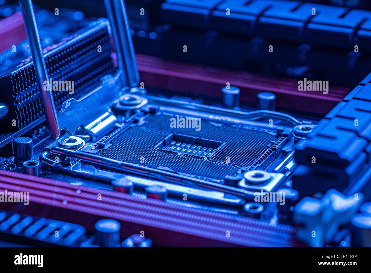 Detail of a Cpu socket in a motherboard of a gaming pc in bluie light ...