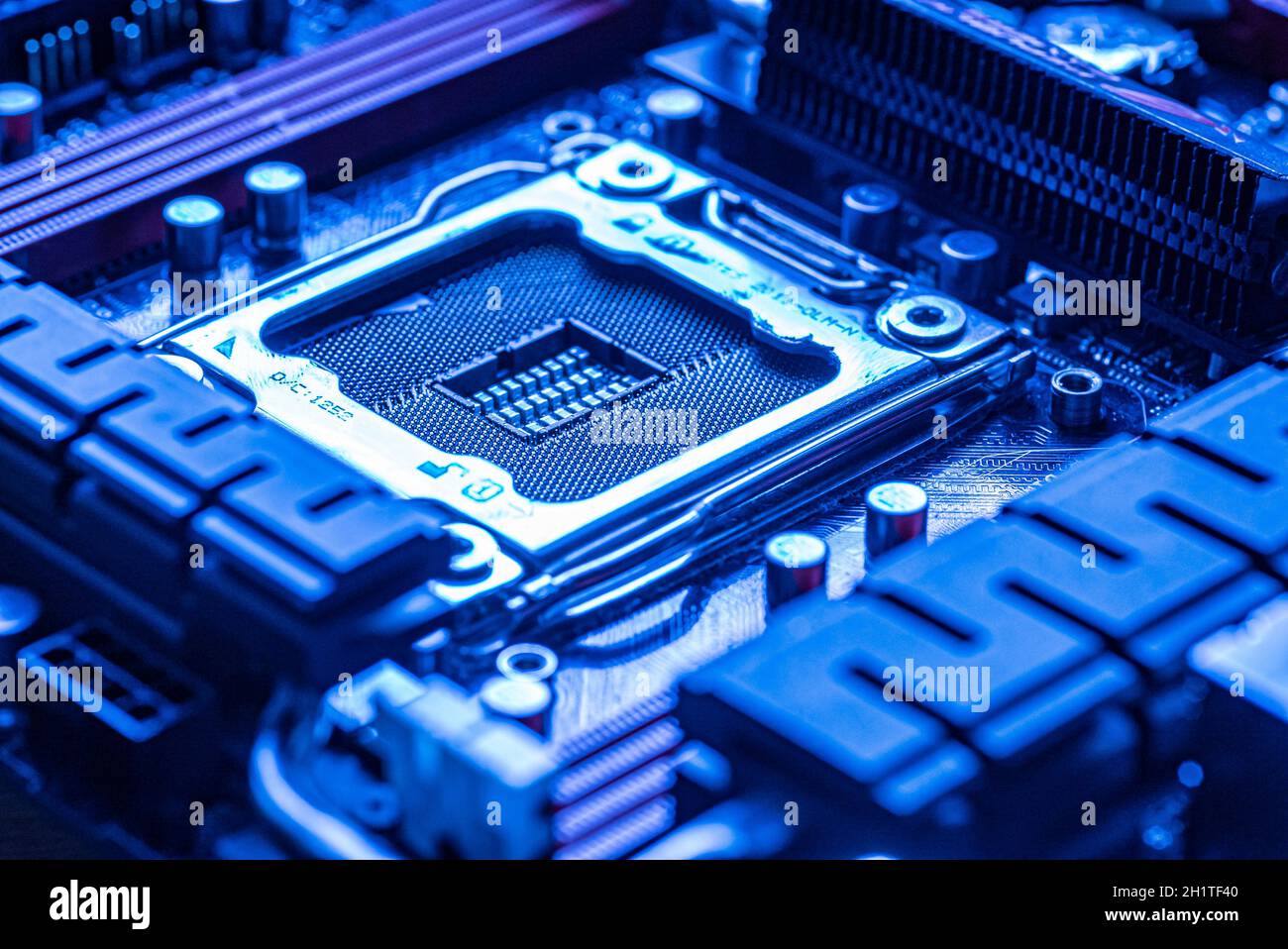 Detail of a Cpu socket in a motherboard of a gaming pc in bluie light ...