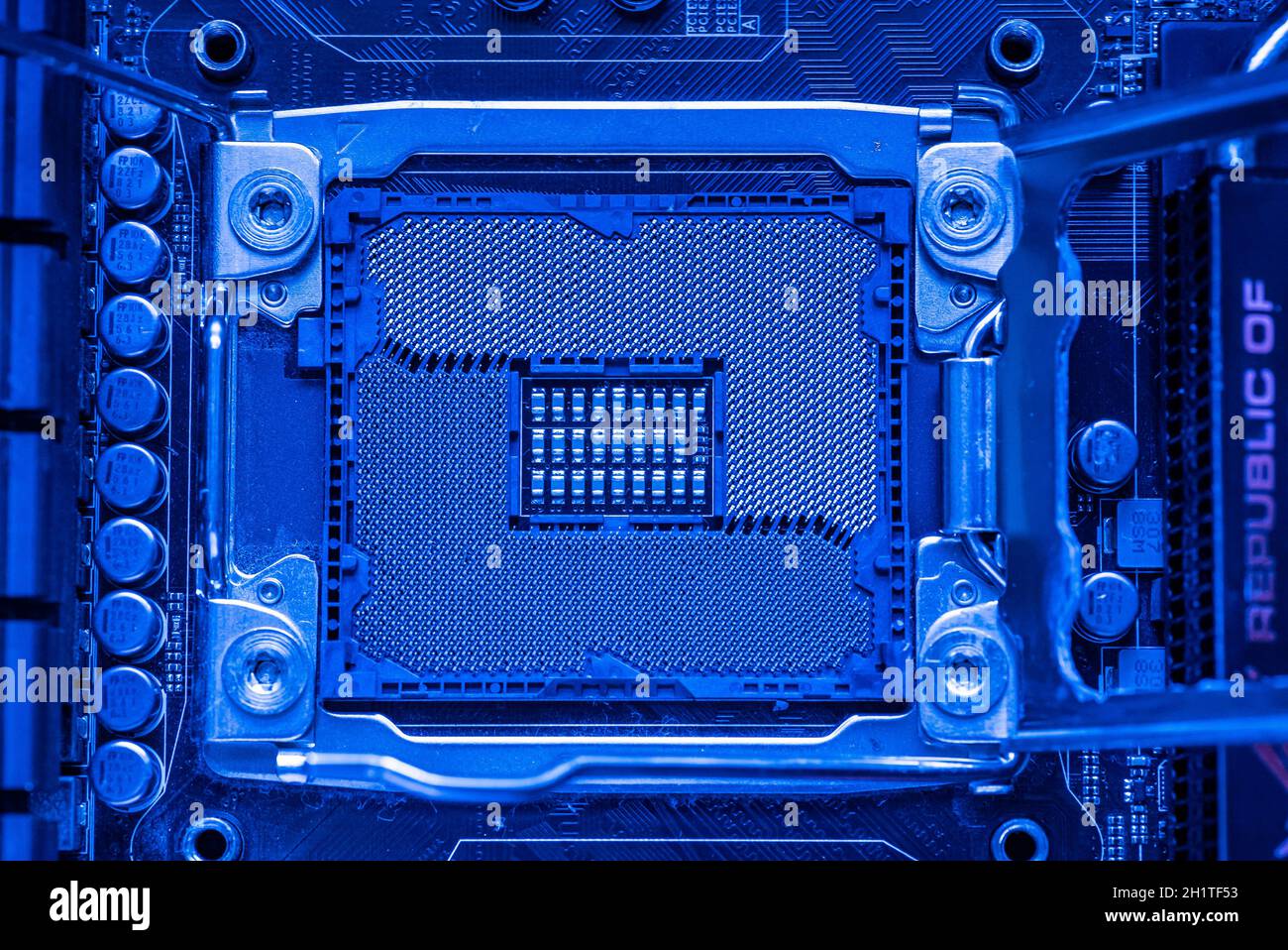 Detail of a Cpu socket in a motherboard of a gaming pc in bluie light ...