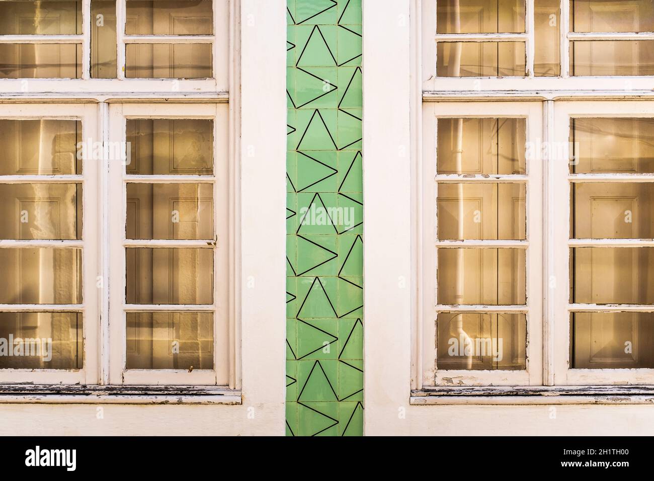Facade of an old house in Aveiro (Portugal) with white wooden windows ...