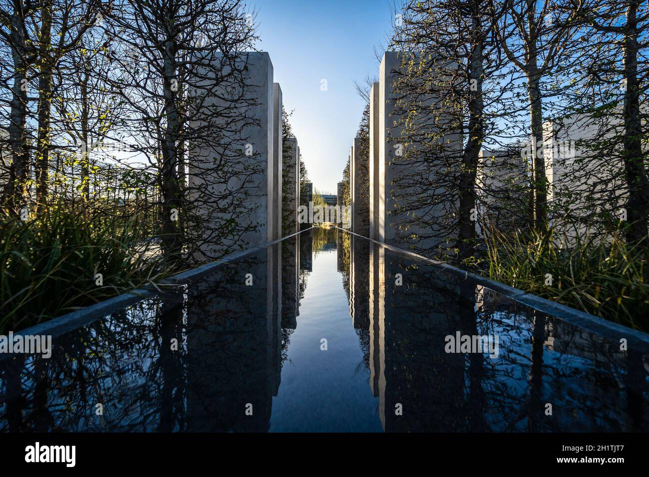 Pylons reflecting in the water and receding into the distance. Abstract ...