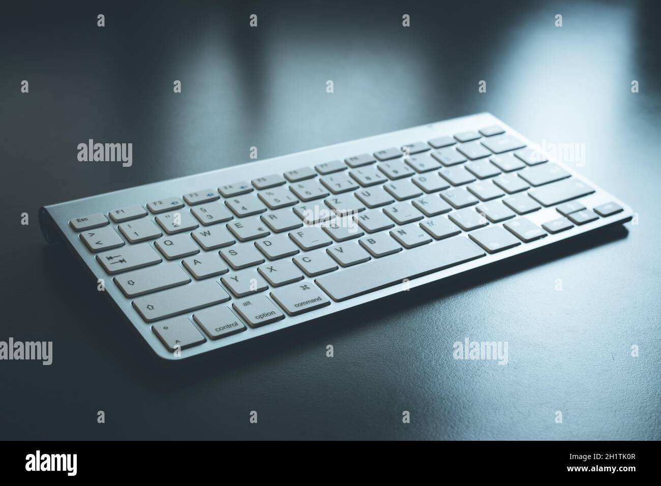 White keyboard lying on the grey table Stock Photo - Alamy