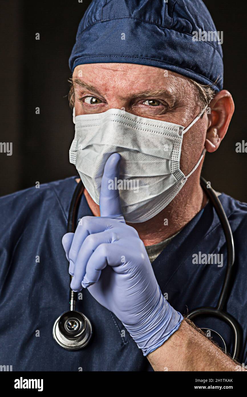 Secretive Doctor or Nurse With Finger in Front of Mouth wearing ...
