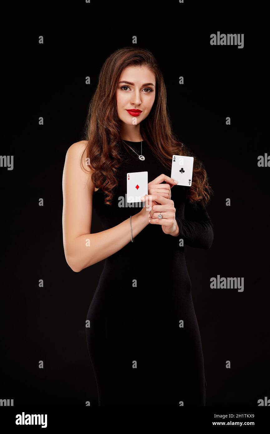 Attractive young woman holding the winning combination of poker cards ...