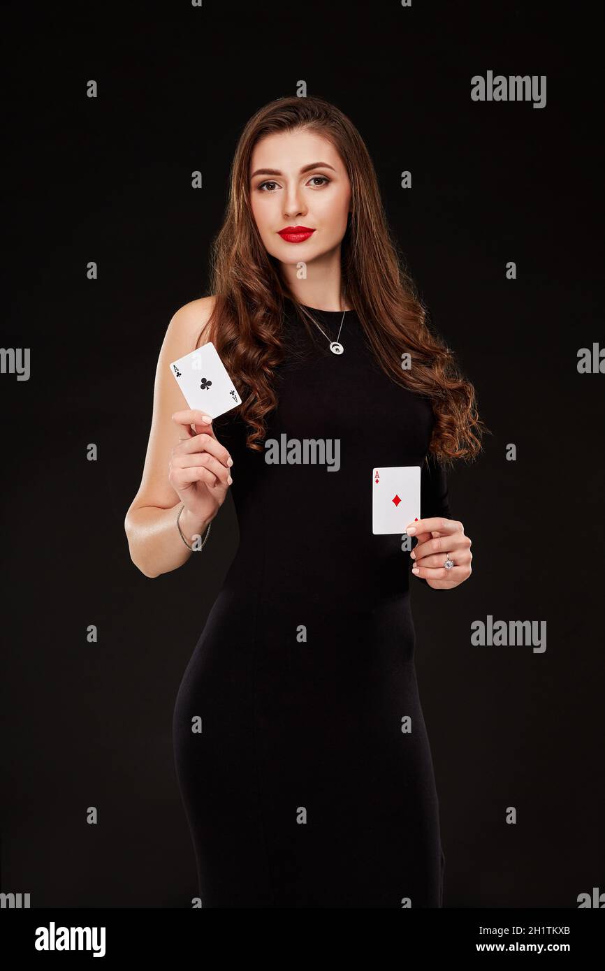 Attractive young woman holding the winning combination of poker cards ...