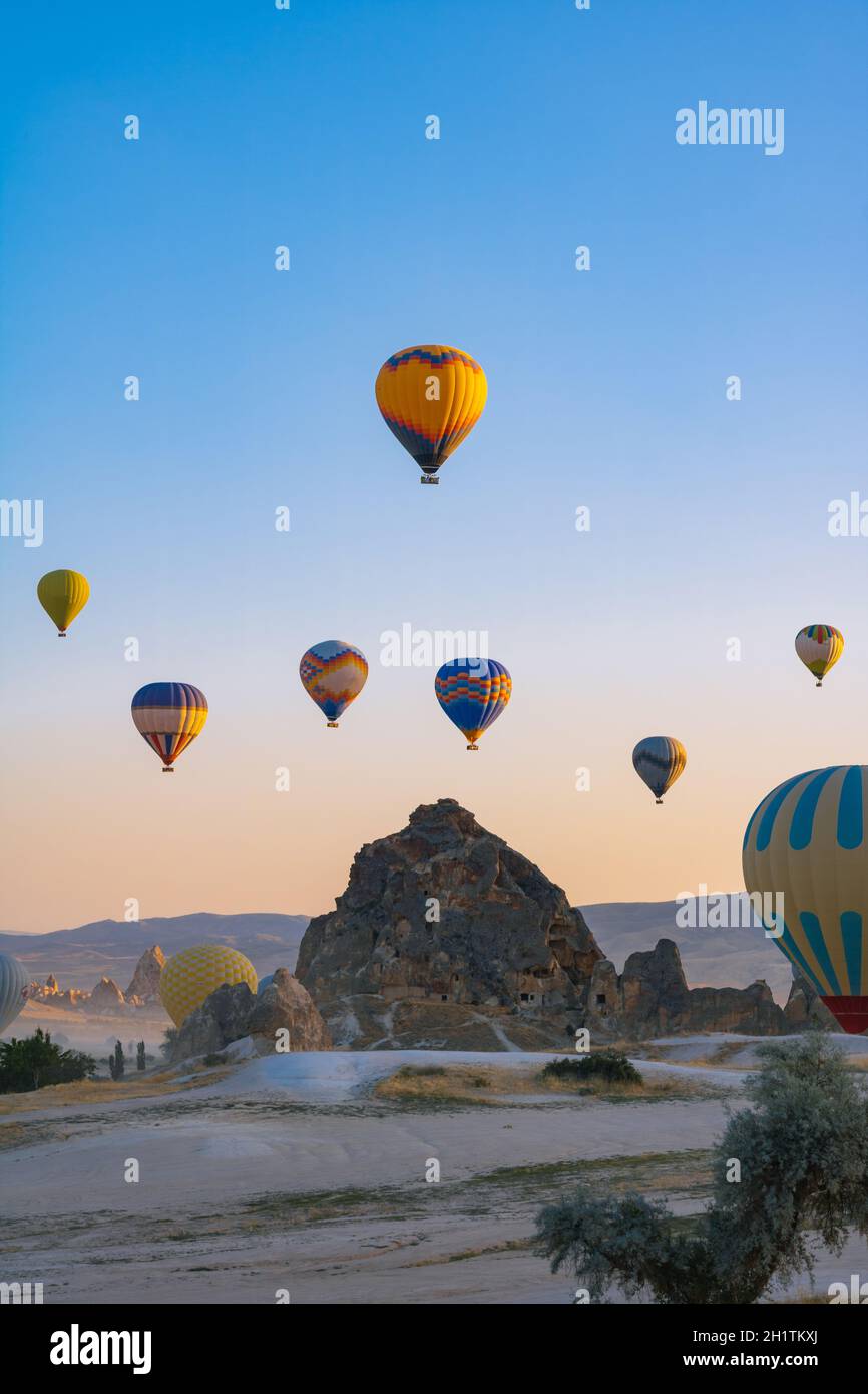 Hot air balloons and fairy chimneys in Cappadocia Turkey Stock Photo ...