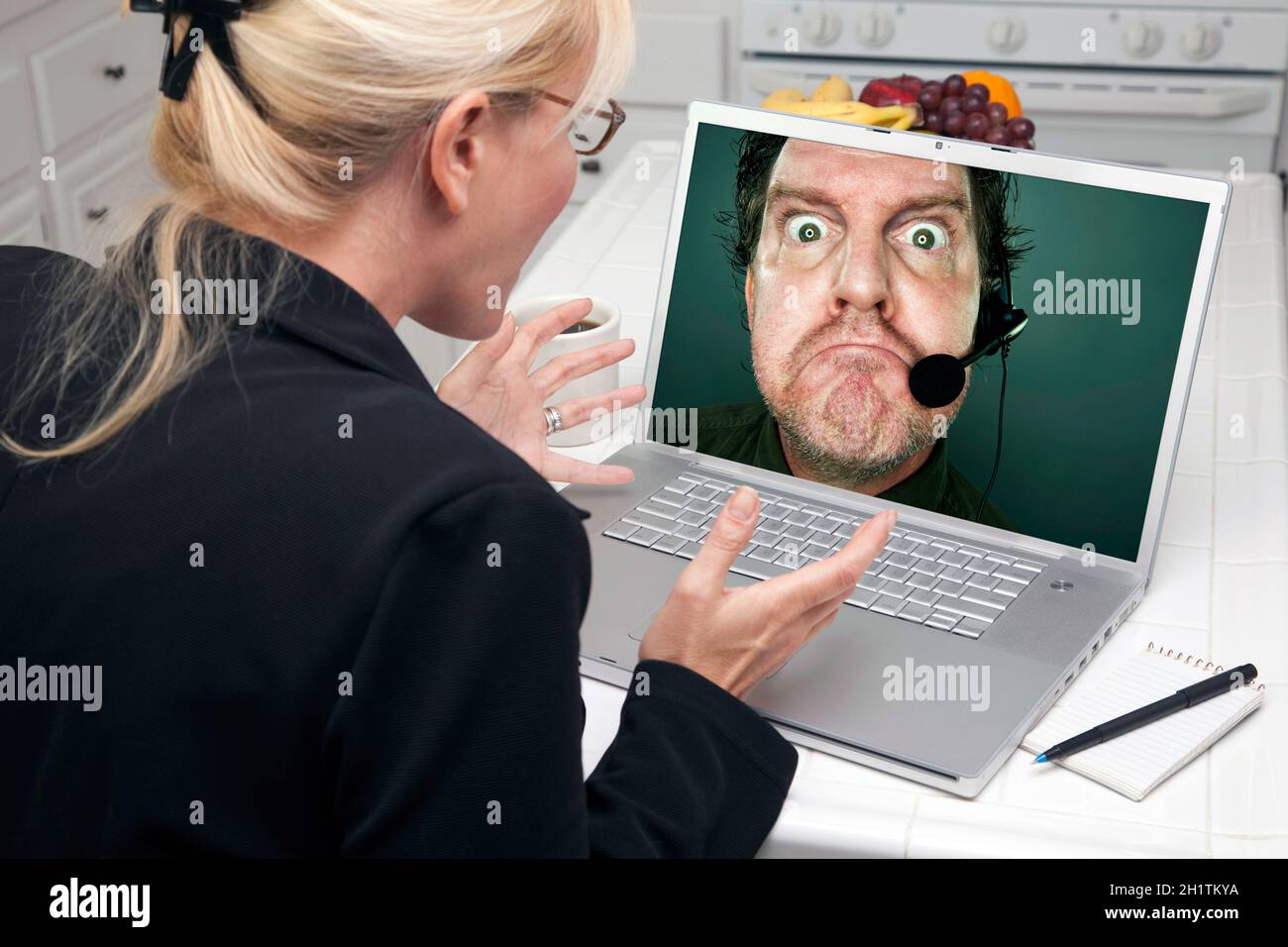 Shocked Woman In Kitchen Using Laptop with Grumpy Customer Support Man ...