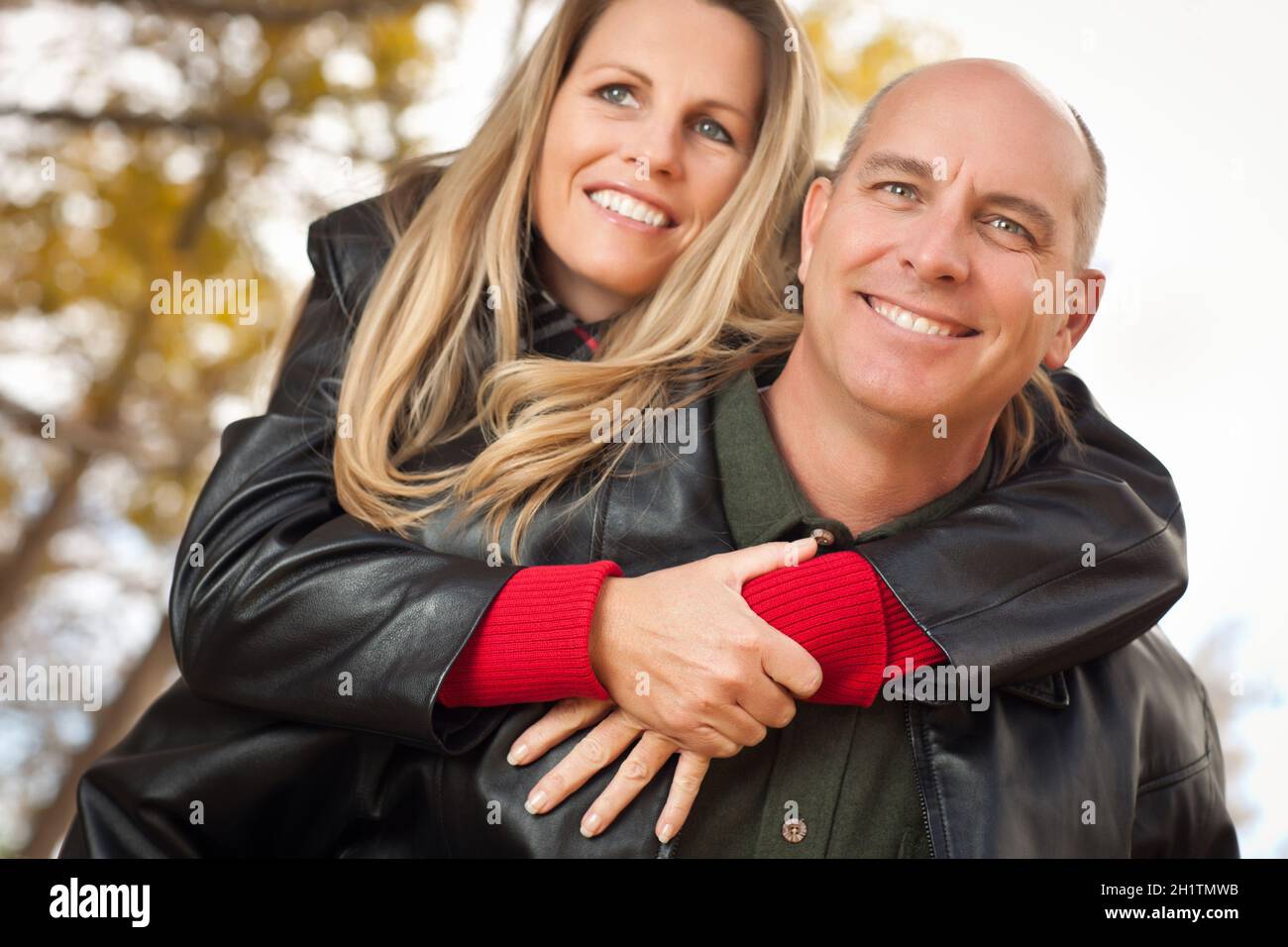Happy, Attractive Couple in Park with Leather Jackets Stock Photo - Alamy