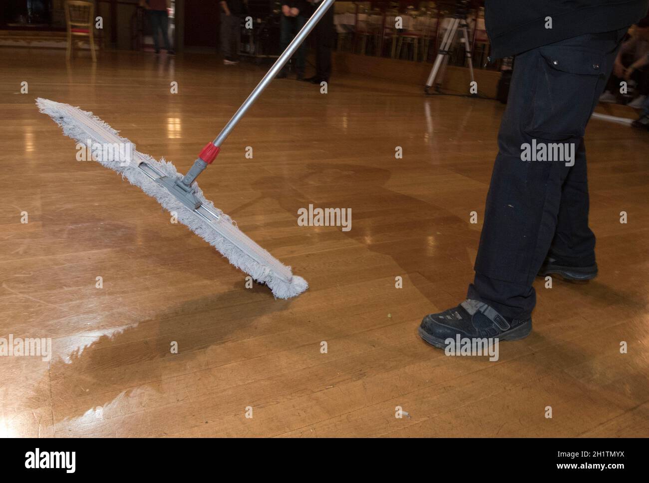 a male person cleaning the floor with a floor mop Stock Photo - Alamy