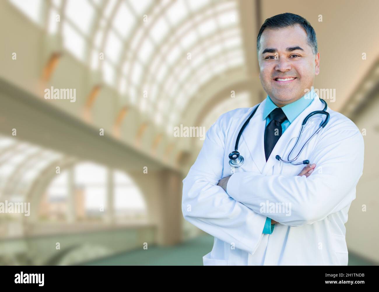 Hispanic male doctor standing hi-res stock photography and images - Alamy