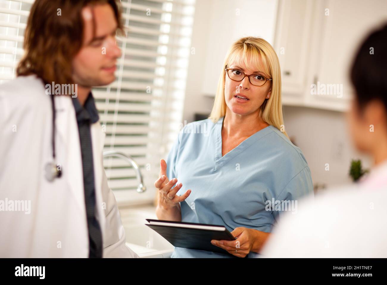 Doctors and Nurses Having A Casual Conversation in The Office Stock ...