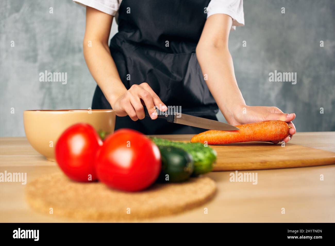 housewife on the kitchen cutting vegetables cutting board Stock Photo ...