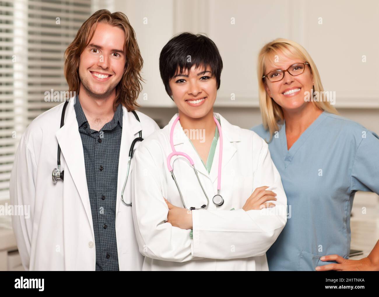 Three Smiling Male and Female Doctors or Nurses in the Office Stock ...