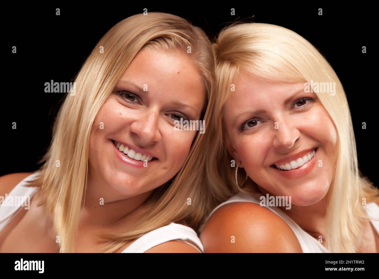 Two Beautiful Smiling Sisters Portrait Isolated on a Black Background ...