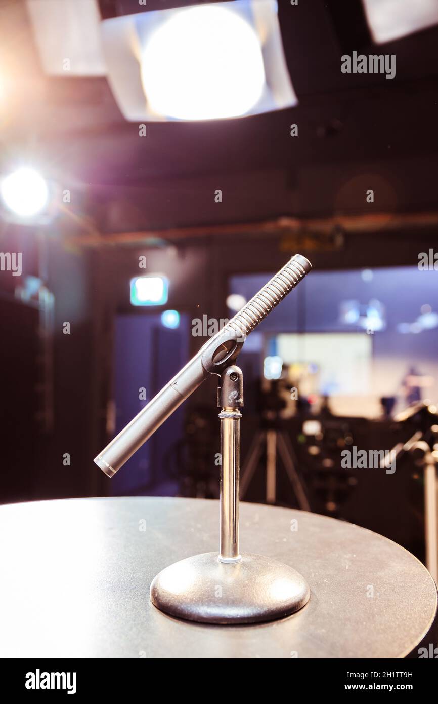 Metal microphone in the studio, studio lights in the blurry background ...