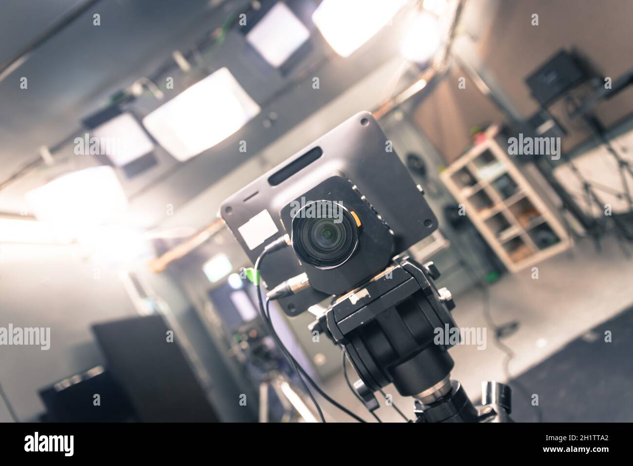 Lens of a film camera in an television broadcasting studio, spotlights ...