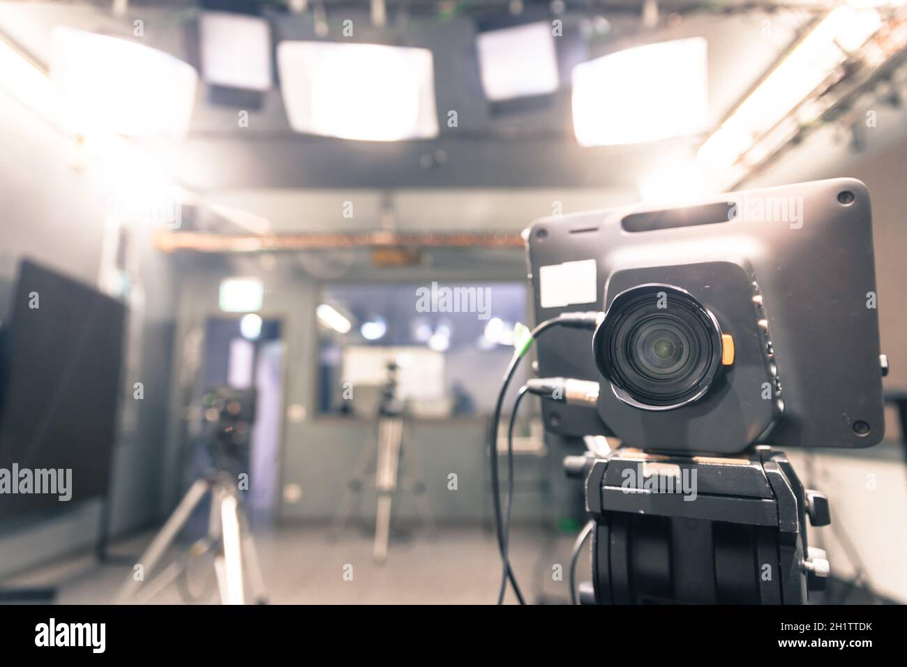Lens of a film camera in an television broadcasting studio, spotlights ...