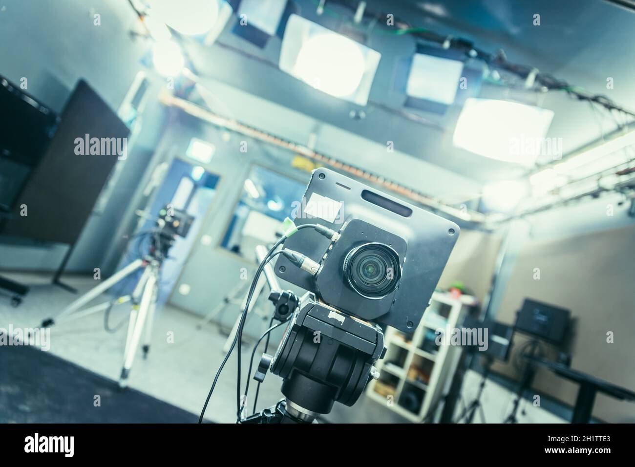 Lens of a film camera in an television broadcasting studio, spotlights ...