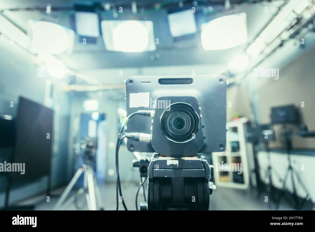 Lens of a film camera in an television broadcasting studio, spotlights ...