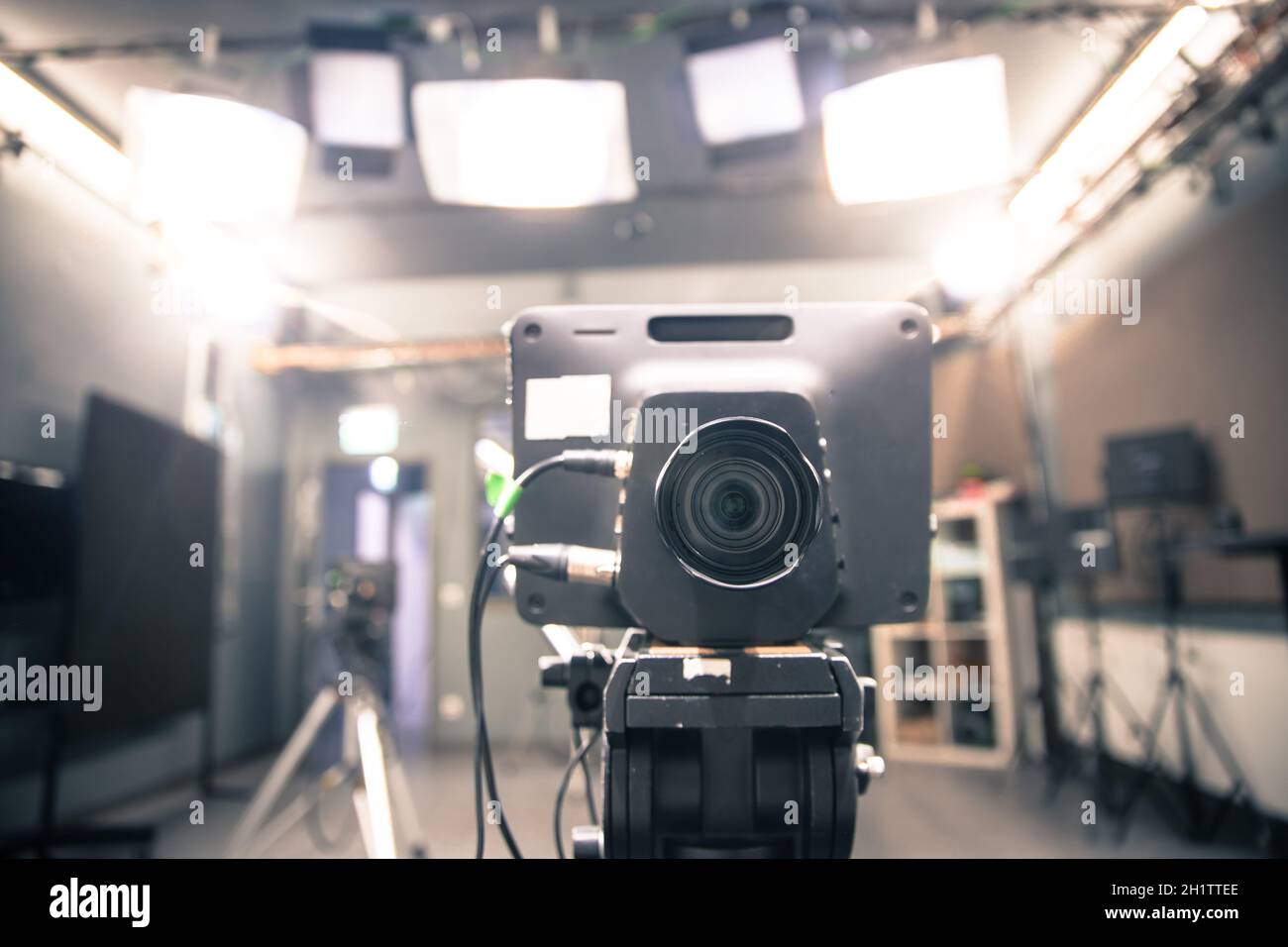 Lens of a film camera in an television broadcasting studio, spotlights ...