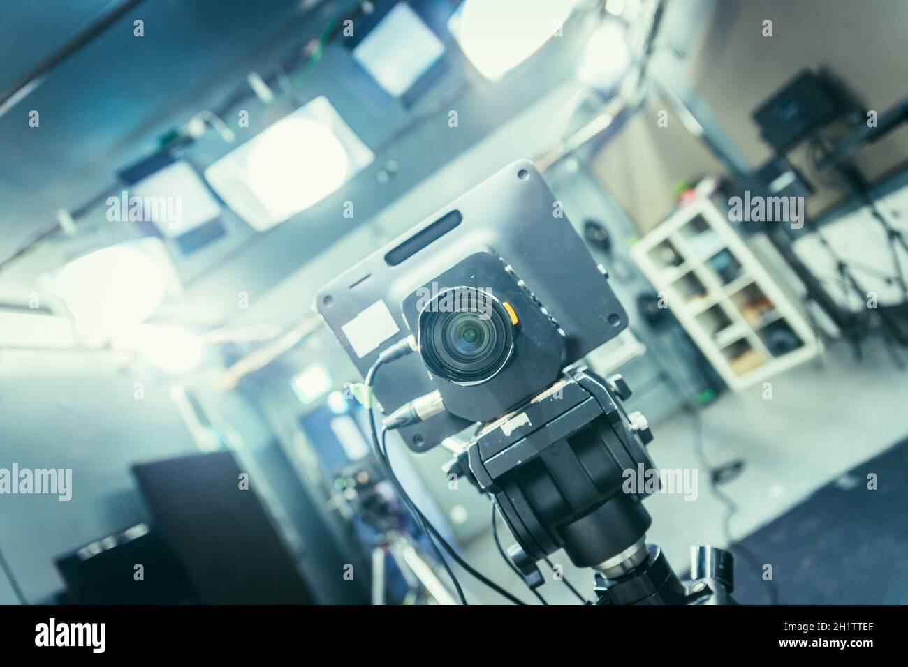 Lens of a film camera in an television broadcasting studio, spotlights ...