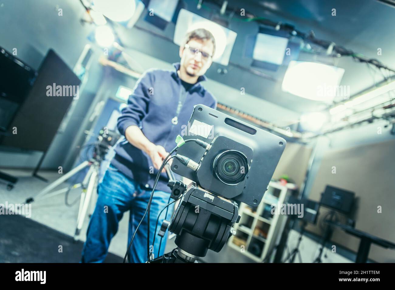 Lens of a film camera in an television broadcasting studio, spotlights ...