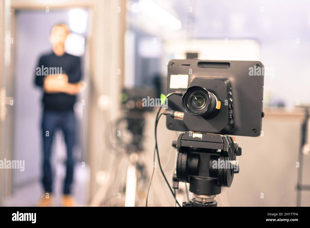 Lens of a film camera in an television broadcasting studio, spotlights ...