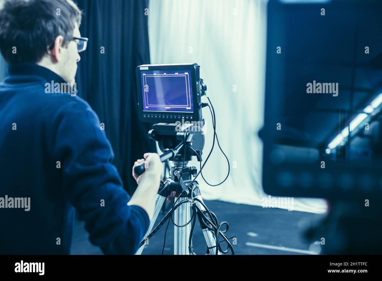 Man operating recording a tv broadcast camera hi-res stock photography ...