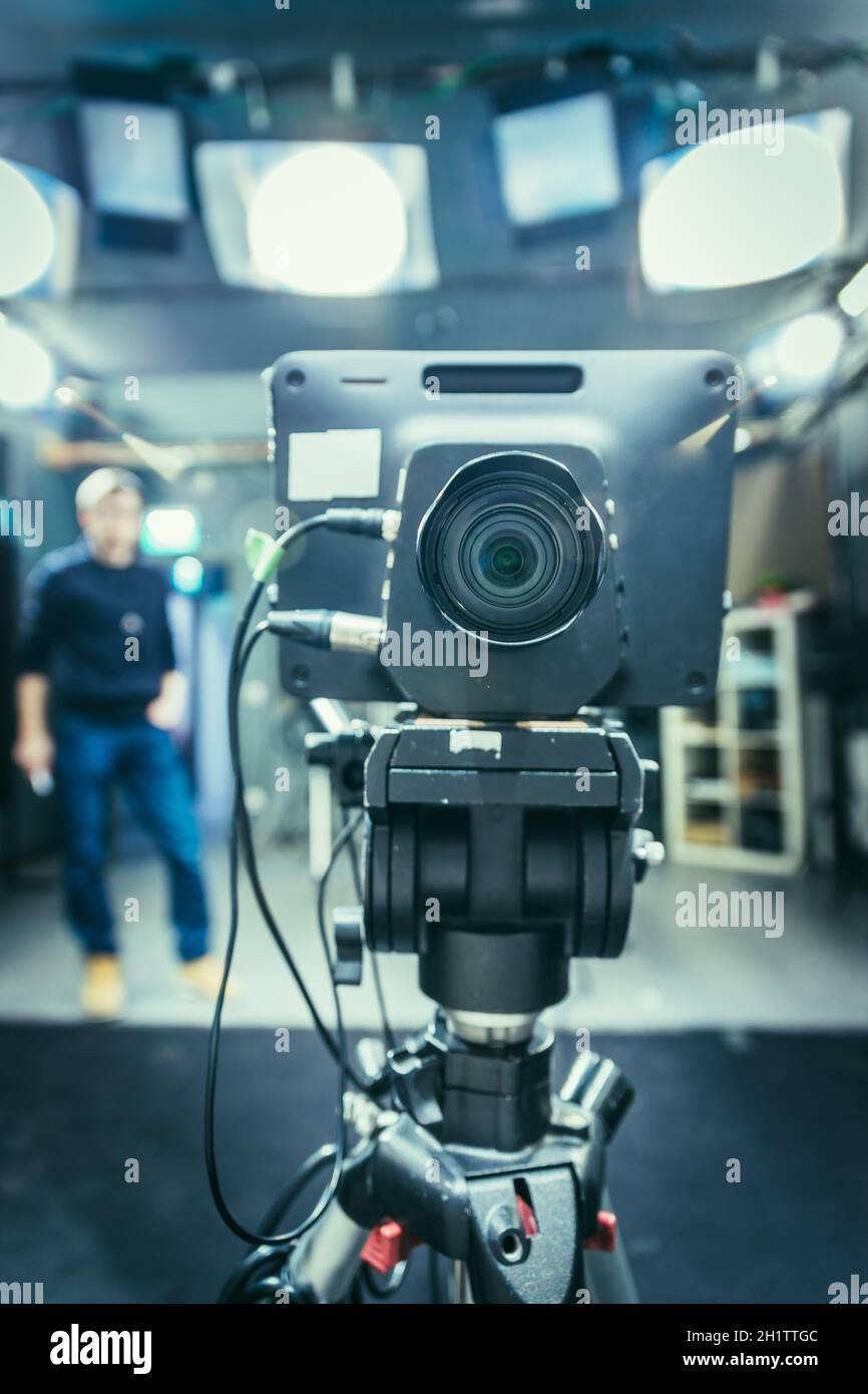 Lens of a film camera in an television broadcasting studio, spotlights ...