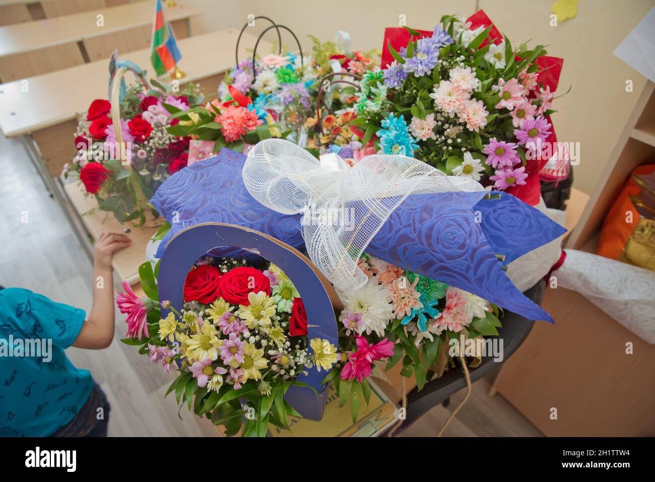 Flowers given to the teacher on the school day are on the student's ...