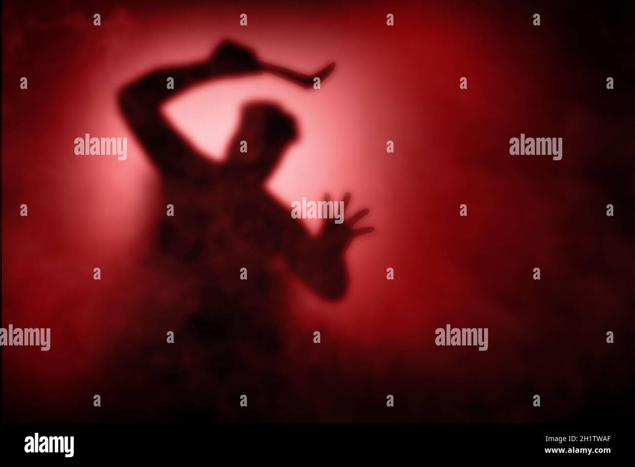 Silhouette of a scary zombie holding sickle with dramatic background ...