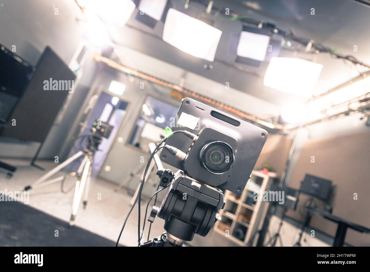 Lens of a film camera in an television broadcasting studio, spotlights ...