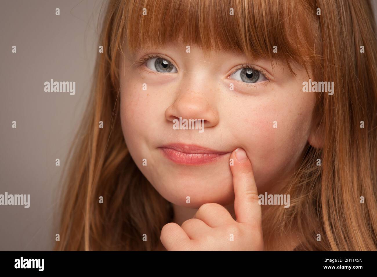 Fun Portrait of an Adorable Red Haired Girl on a Grey Background Stock ...