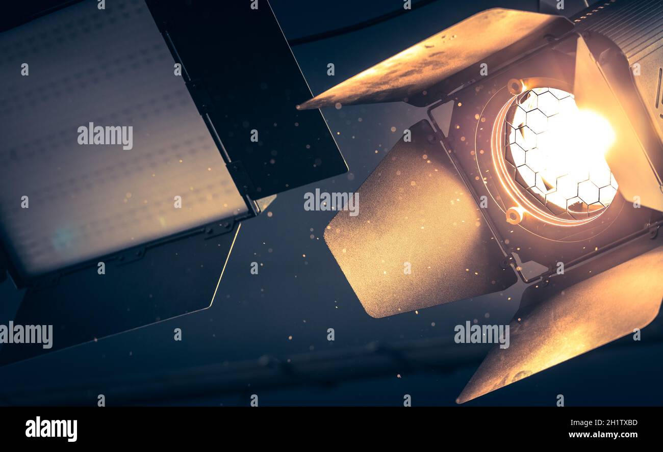 Professional orange studio spotlight hanging on the ceiling. Lighted ...