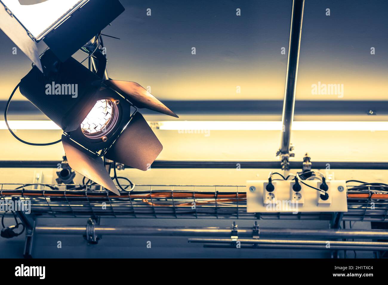 Professional orange studio spotlight hanging on the ceiling Stock Photo ...