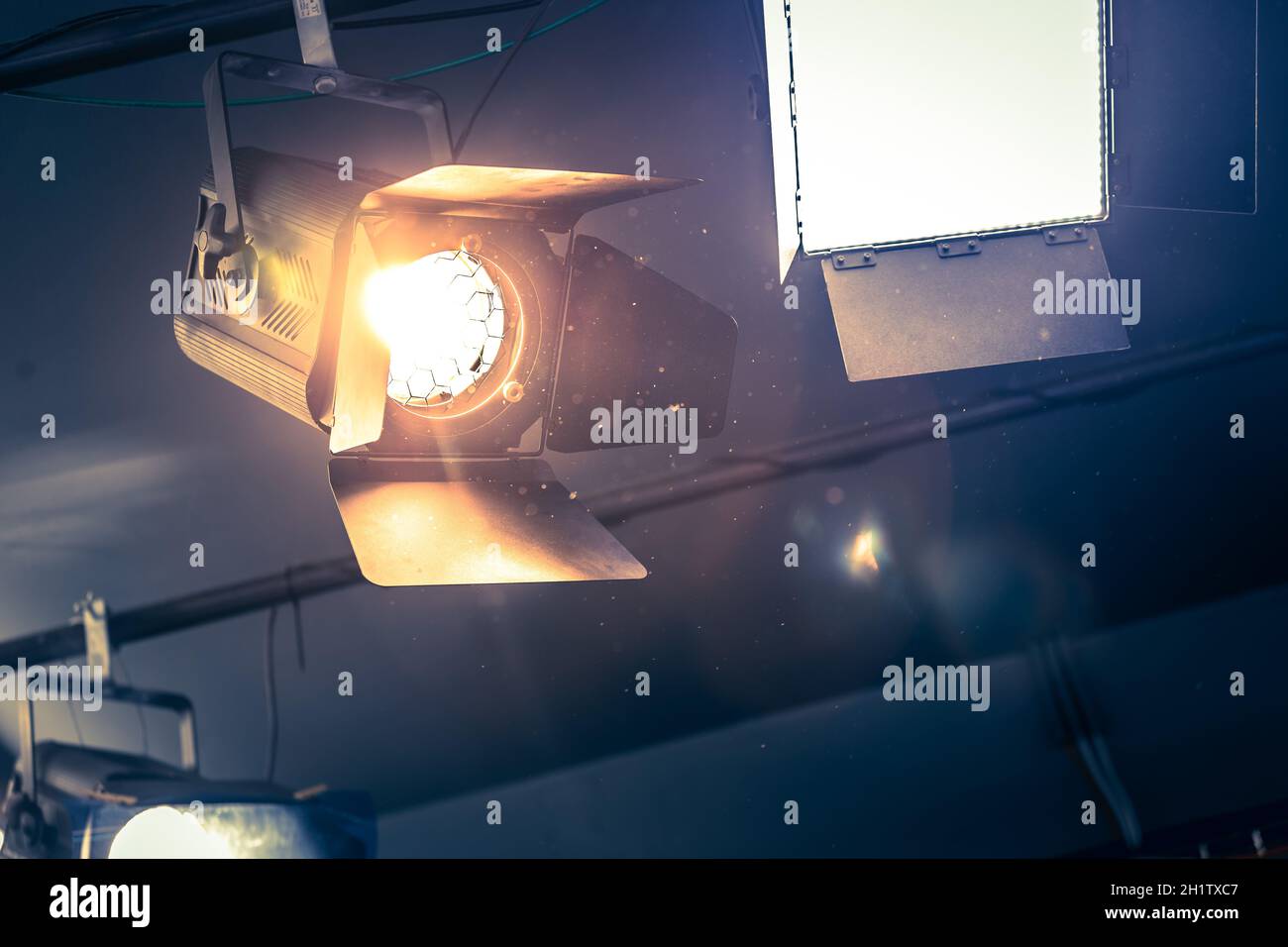 Professional orange studio spotlight hanging on the ceiling Stock Photo ...